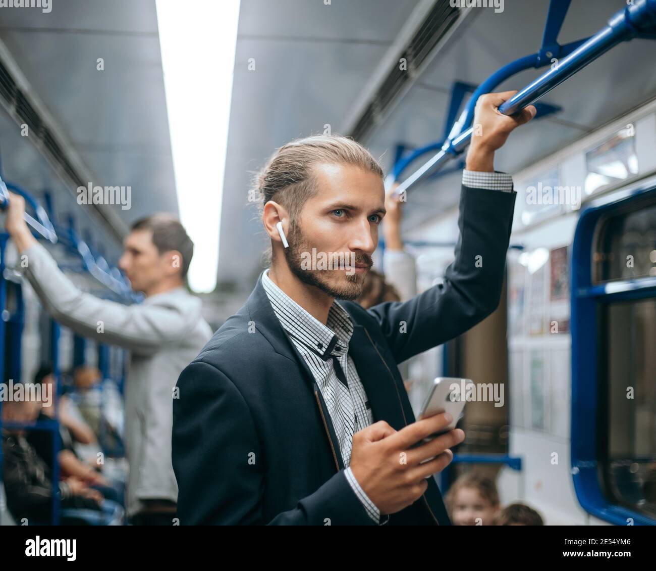 Man looking the mobile in metro hi-res stock photography and images - Alamy