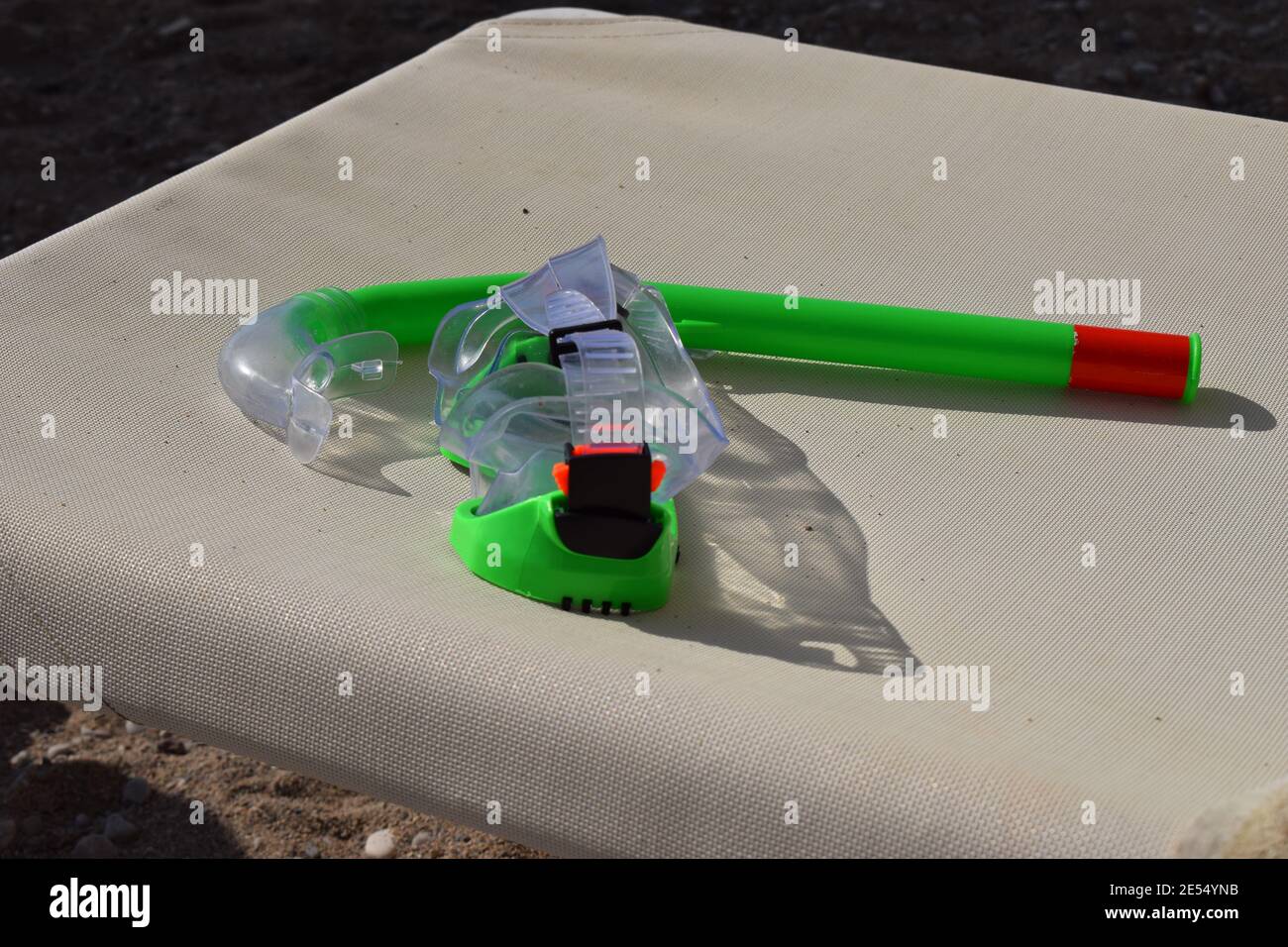Snorkel and scuba mask on the beach chair near the sea. Diving with a ...