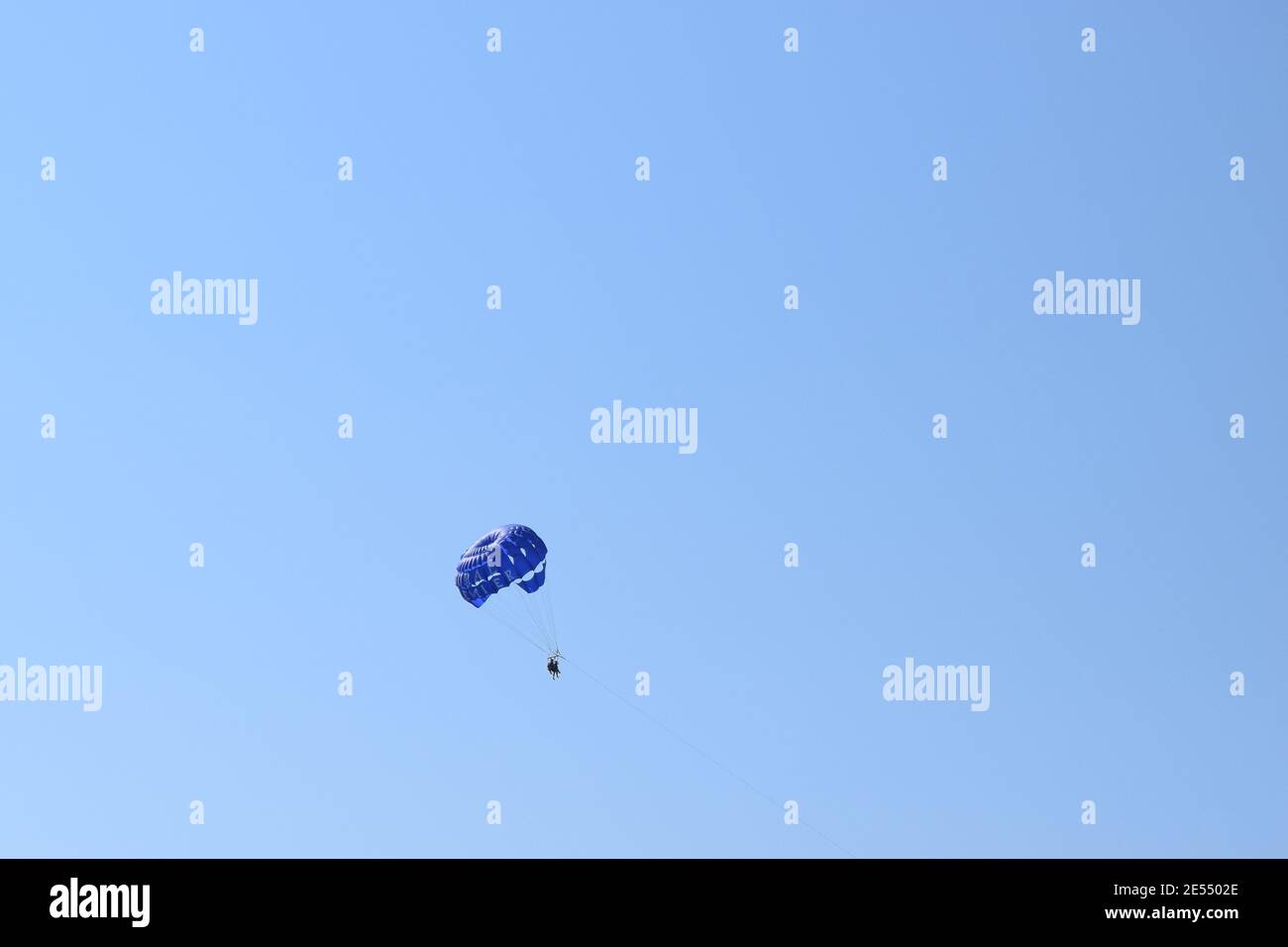 Recreational parakiting background - silhouetes of three people under ...