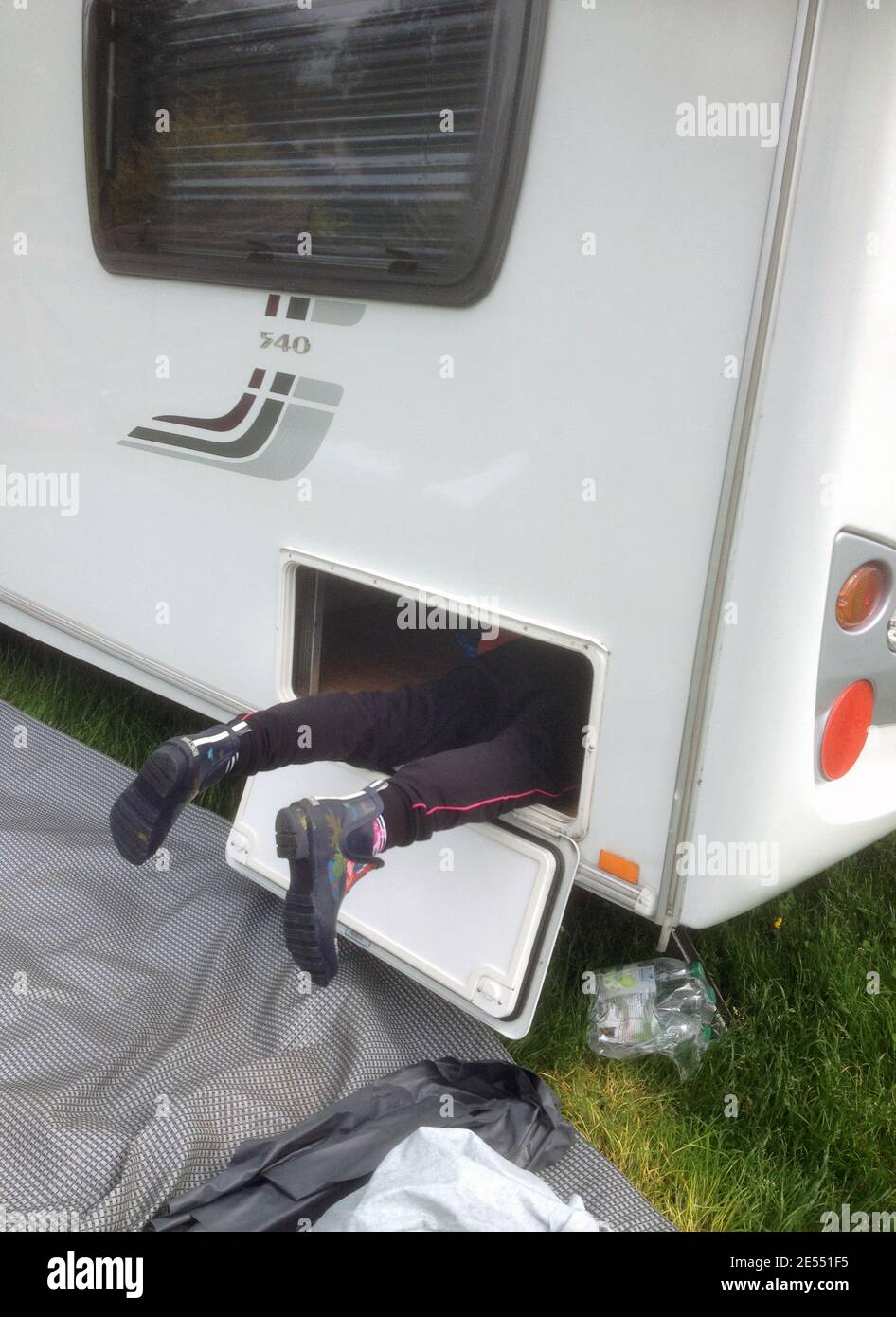 women crawling into caravan side locker to get to something awkward ...