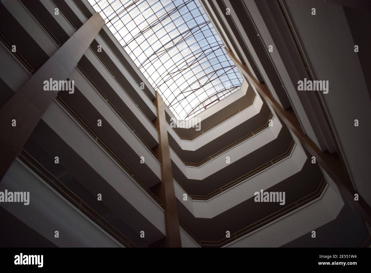 Bottom view of hotel hall staircase and beautiful geometric ceiling ...