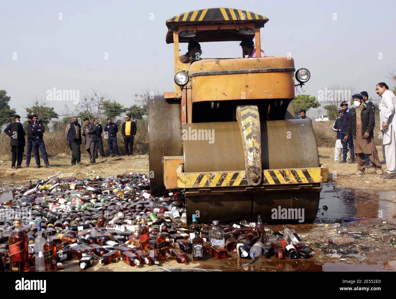 View of destroying liquor bottles and burning pile of confiscated drugs ...
