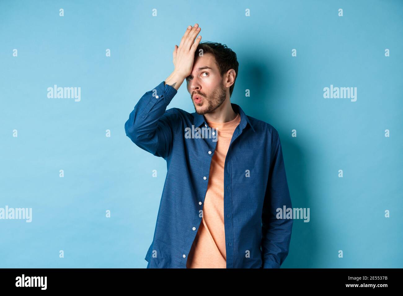 Annoyed man making facepalm and roll eyes from something stupid ...