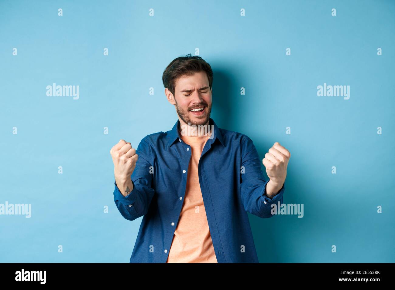 Image of happy man celebrating success, shouting yes and shaking ...