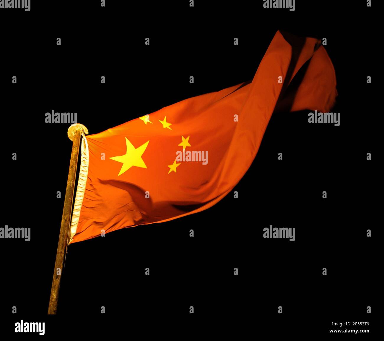 Chinese flag against black sky flying in the wind Stock Photo - Alamy