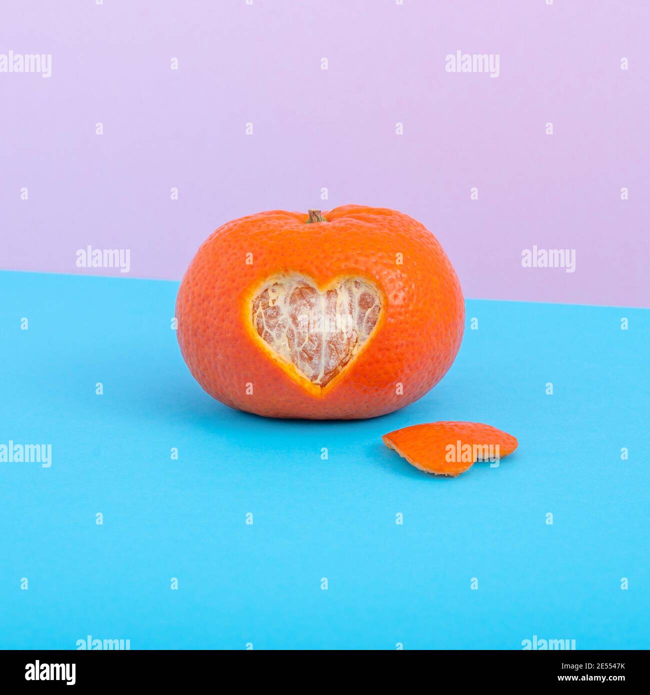 Vertical shot of a tangerine peeled in a heart-shape Stock Photo - Alamy