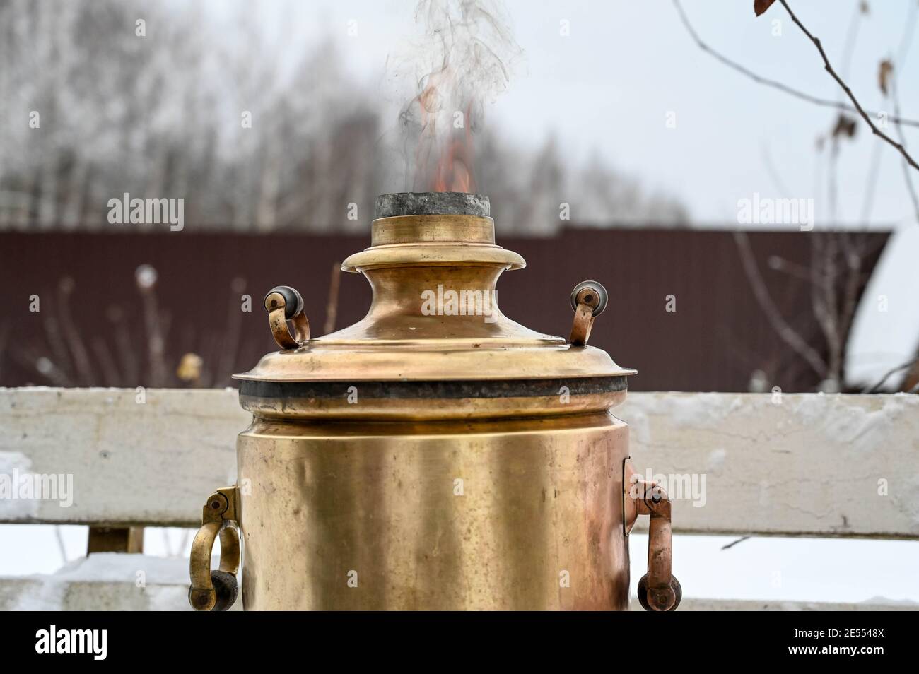 Heating samovar. Russian traditional tea machine. Smoke and flame from ...