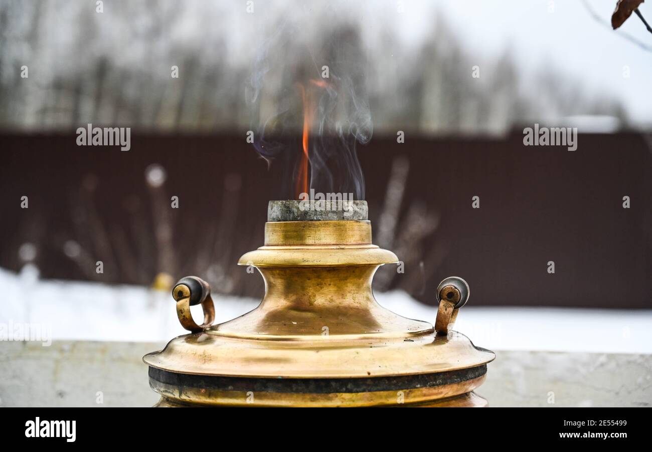 Heating samovar. Russian traditional tea machine. Smoke and flame from ...