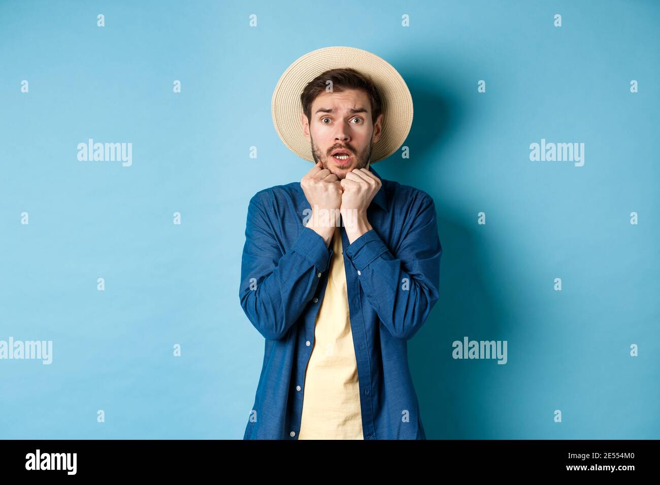Scared young tourist trembling from fear, looking at something scary on ...