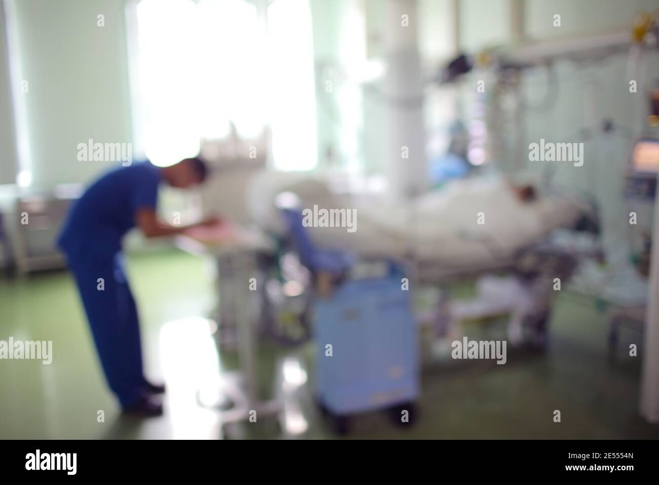 Health service worker monitoring patient's condition and writing down ...