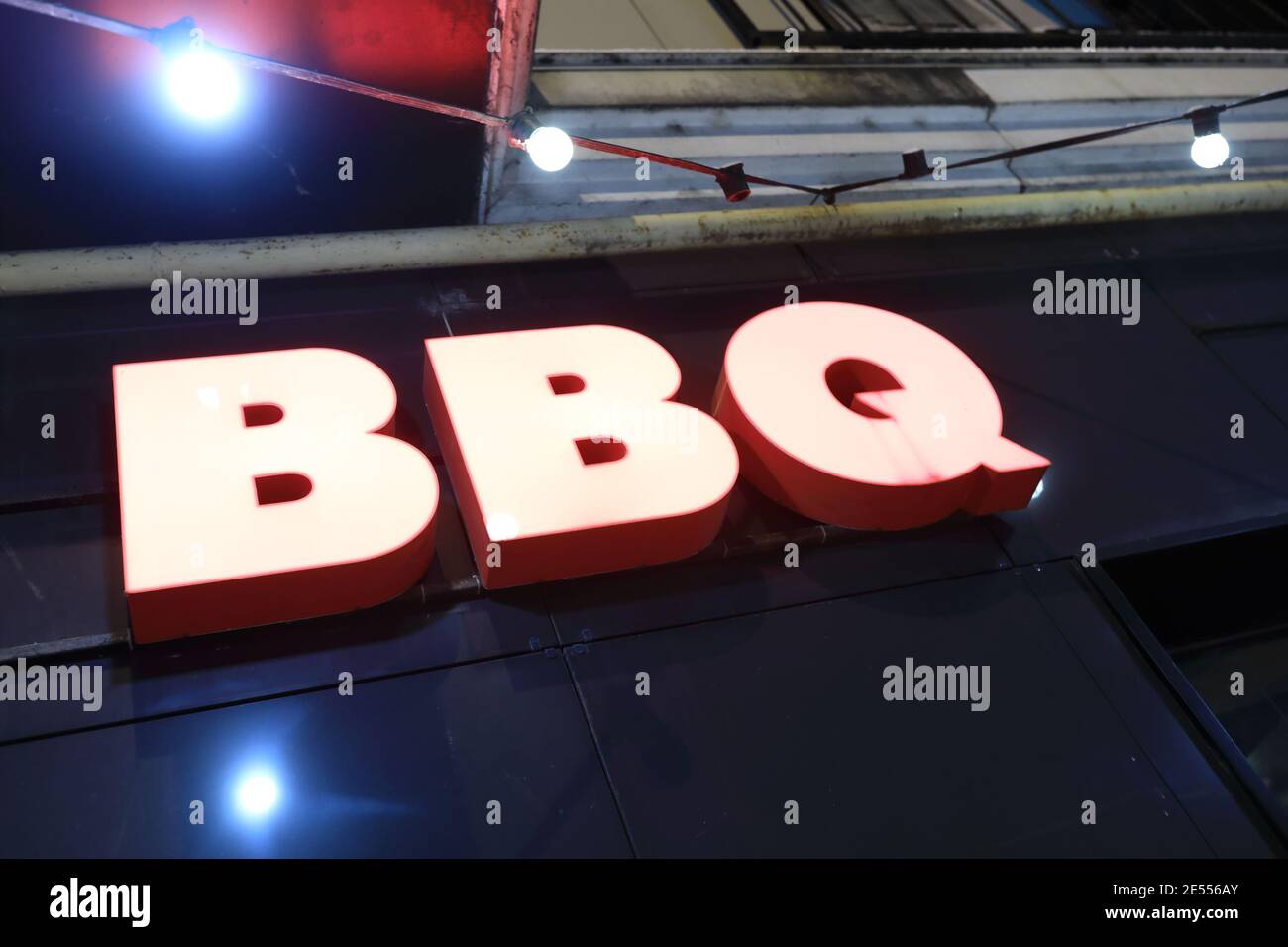 View of glowing bbq signboard at night Stock Photo - Alamy