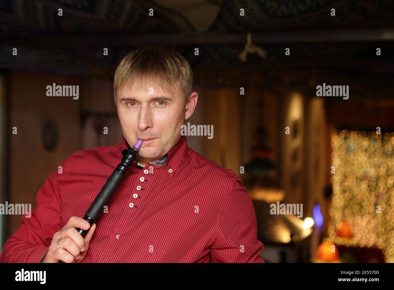 Man smoking shisha in the hookah house Stock Photo - Alamy