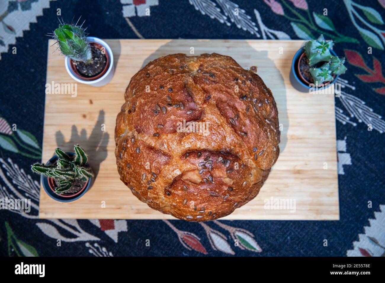 Freshly homemade baked bread on wooden trencher over traditional ...