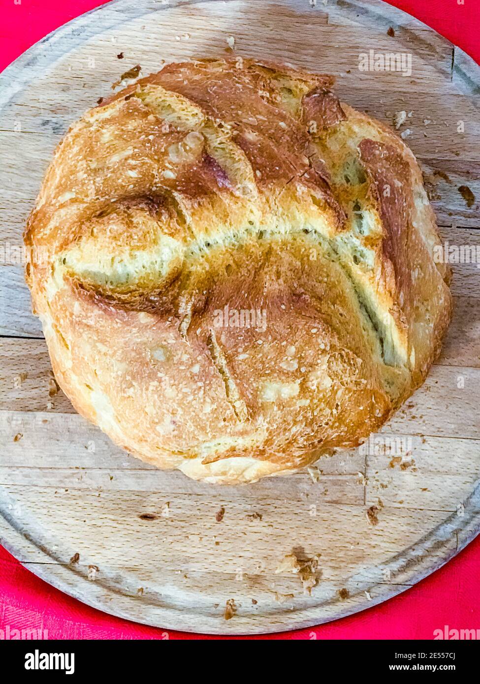 Freshly homemade baked bread on wooden trencher in christmas setting ...
