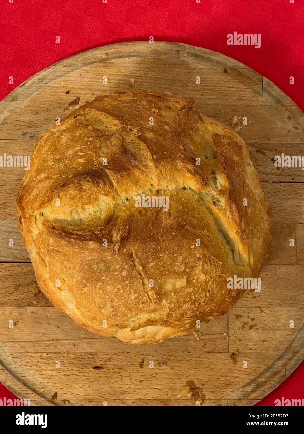 Freshly homemade baked bread on wooden trencher in christmas setting ...