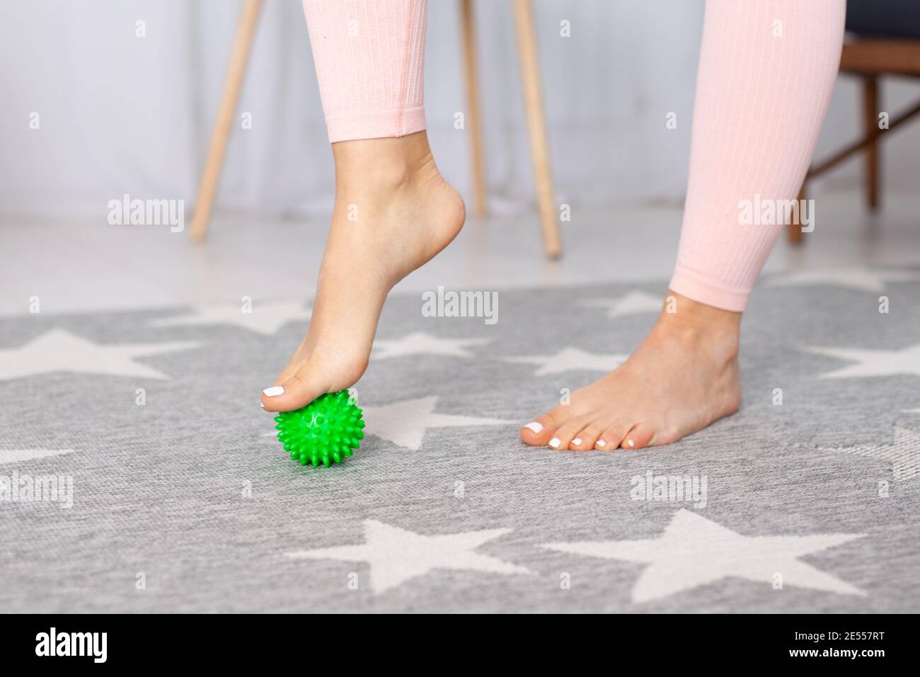 close-up two graceful feet of a young woman, one foot standing on a ...