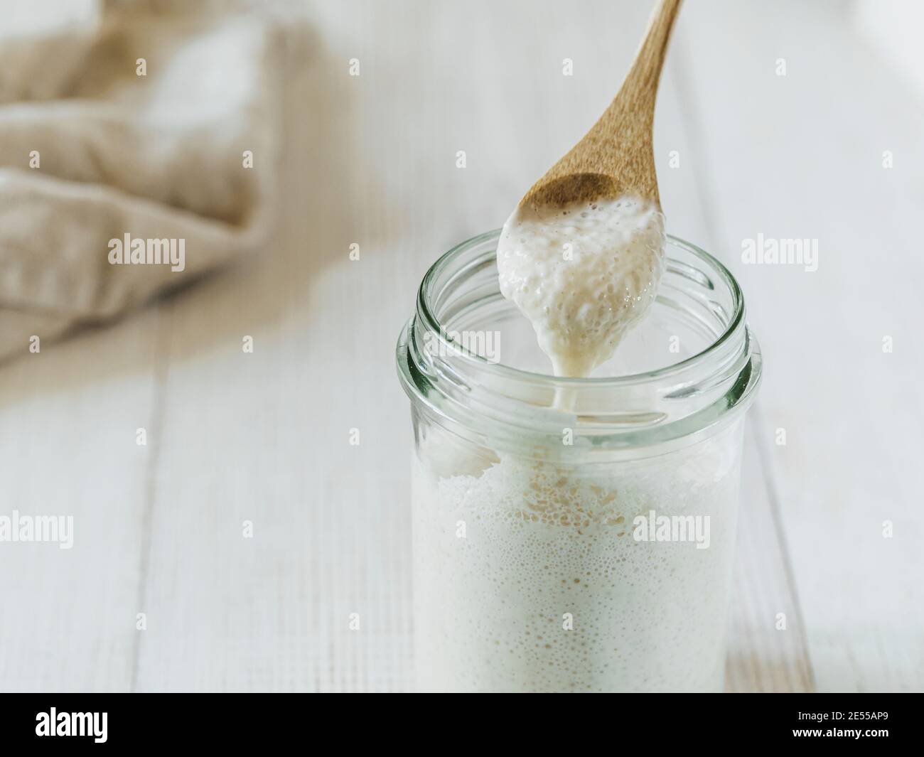 Ready for making bread wheat sourdough starter dripping from wooden ...