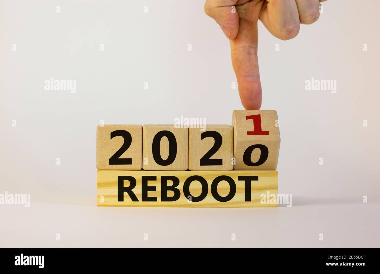 Business concept of new year 2021 reboot. Businessman flips a wooden ...