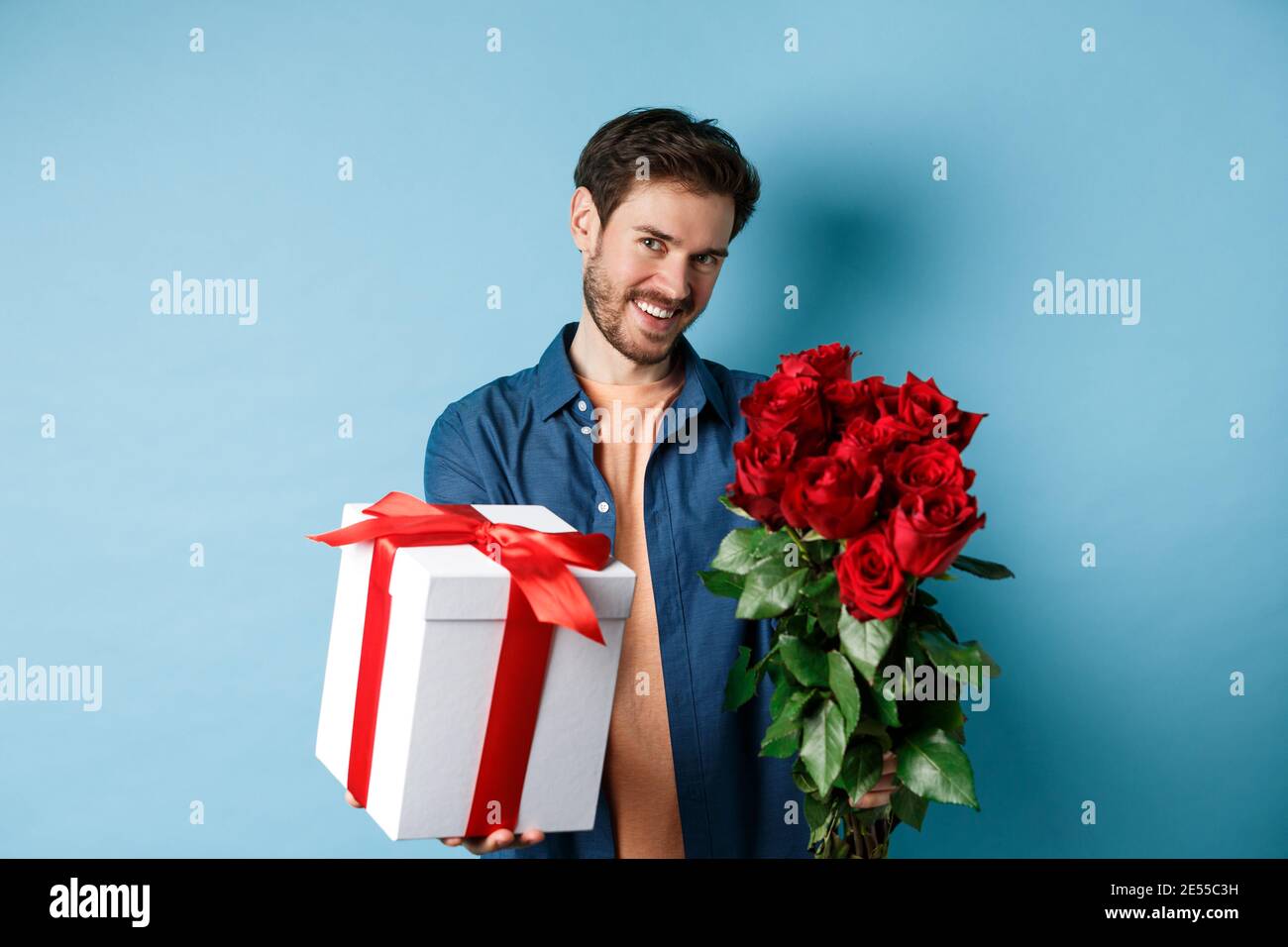 Love and Valentines day concept. Romantic smiling man giving you gift ...