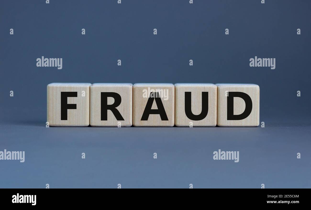 Fraud symbol. Concept word 'fraud' on wooden cubes on a beautiful grey ...