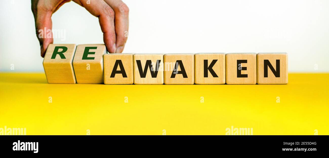 Reawaken symbol. Businessman turns cubes and changes the word 'awaken ...