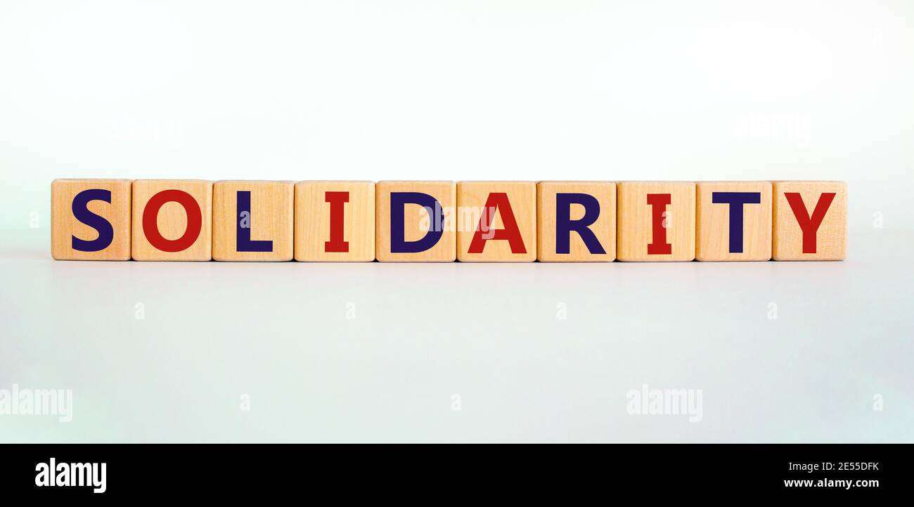 Time to solidarity symbol. Concept word solidarity on wooden cubes on a ...