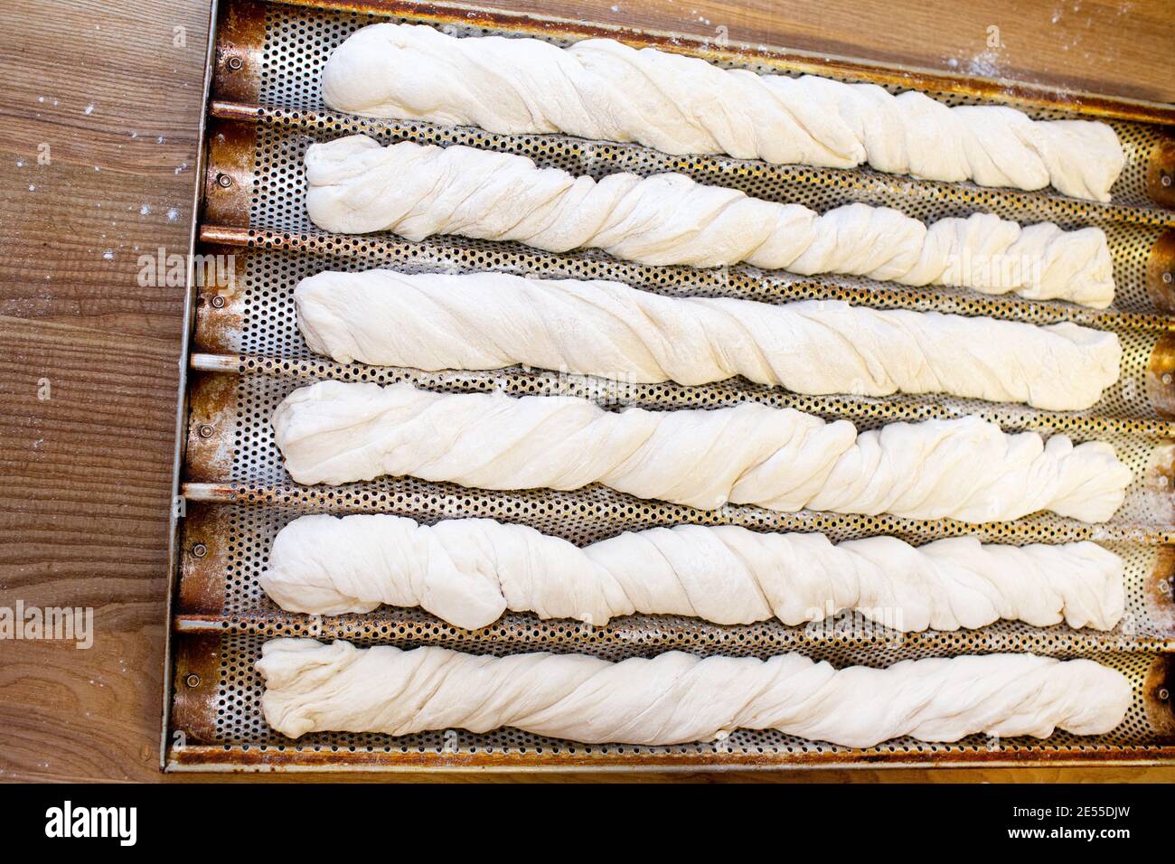 Bread baking process. forming a baguette - French roll Stock Photo - Alamy
