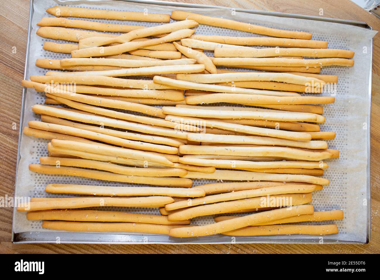 Freshly baked crunchy bread sticks in a wicker basket on display for ...