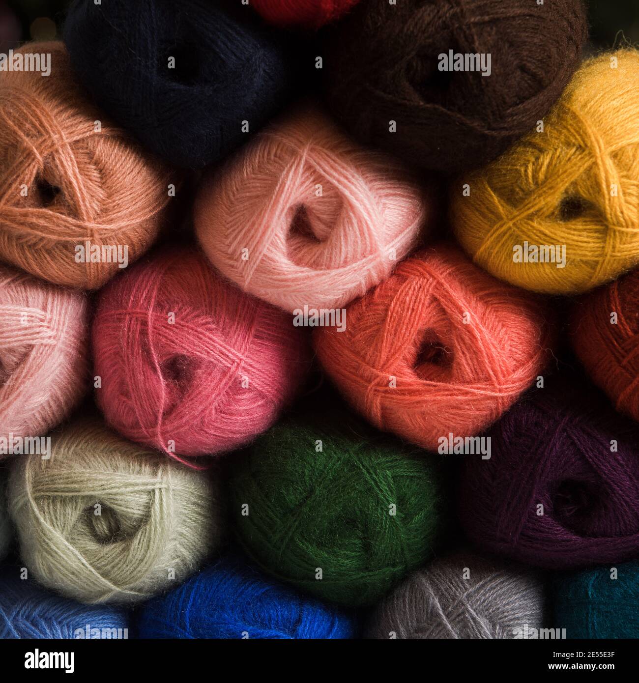 The large threads for yarn of different colors are folded together ...