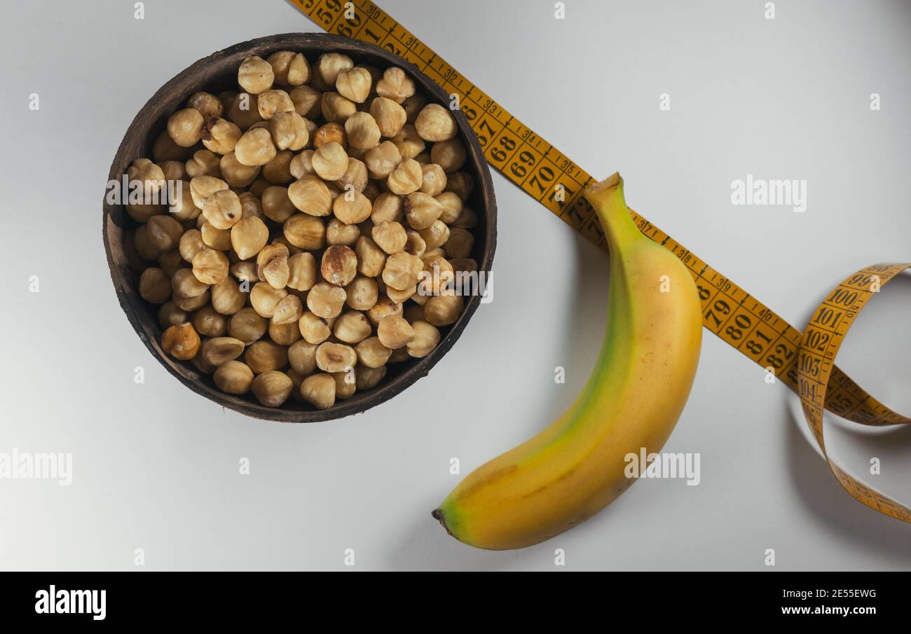 Filled and half hazelnuts on white background. Isolated with banana ...