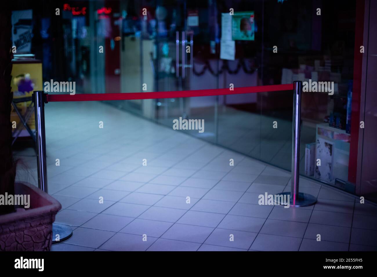 No entry red tape across aisle in shopping centre Stock Photo - Alamy