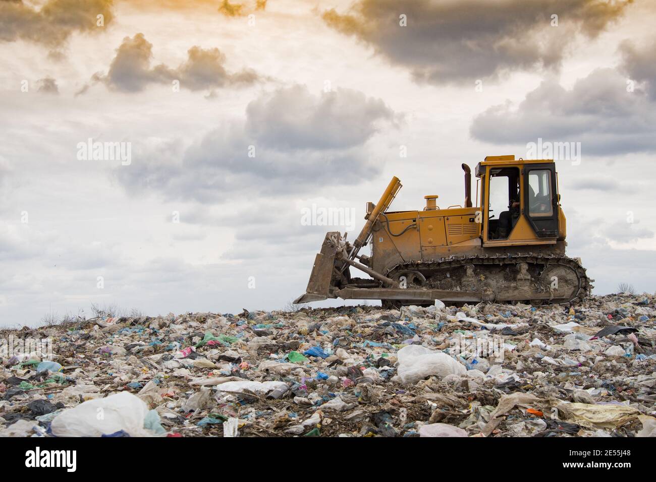 Bulldozer compactor working in landfill of waste Stock Photo - Alamy