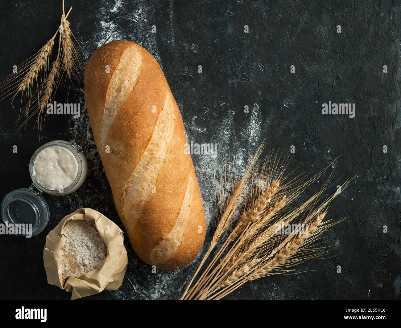 British White Bloomer or European sourdough Baton loaf bread on black ...