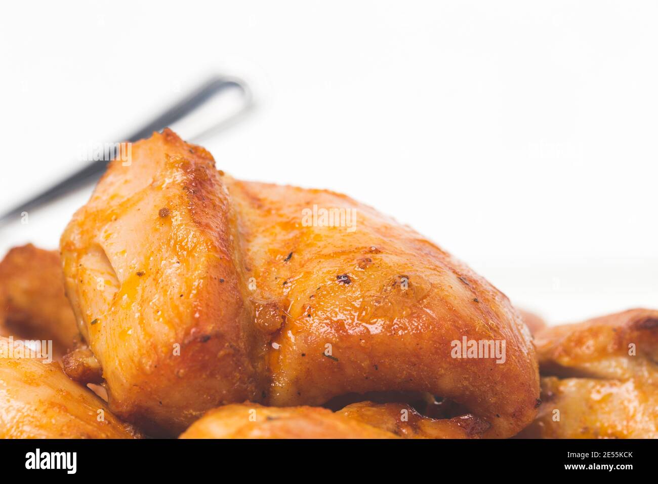 Pieces of fried meat close up on a white background. There is a place ...