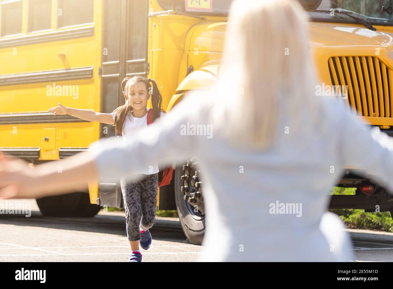 Kids student running into mother's hands to hug her after back to ...