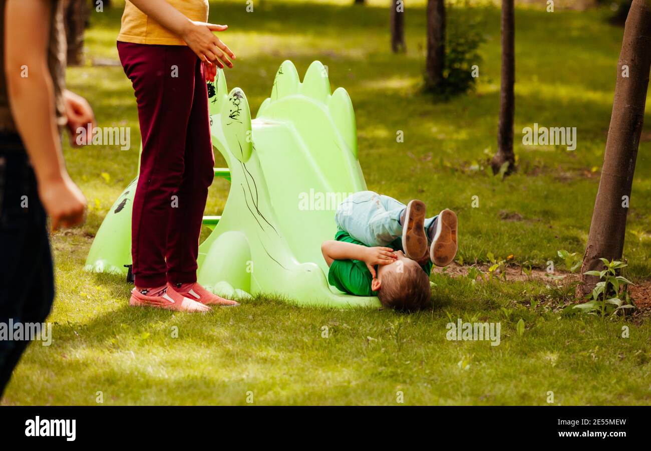 the little boy unsuccessfully descended from a children's slide Stock ...