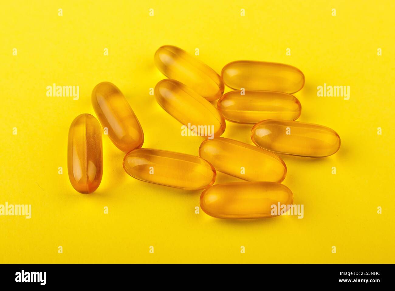 Vitamin D yellow pills on yellow background soft sun light. Medicine ...