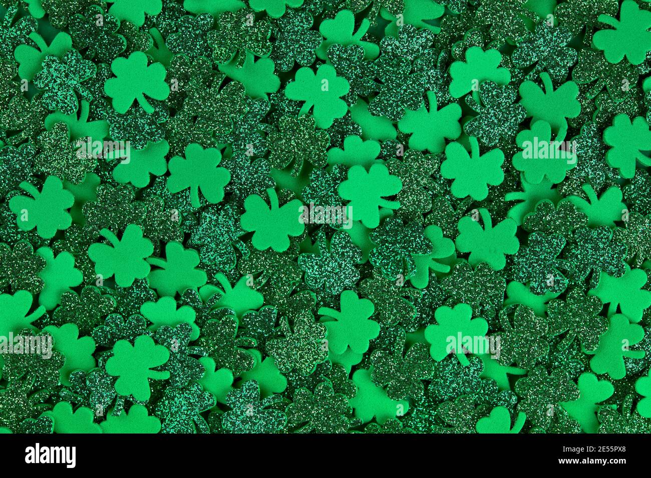 Shamrock confetti texture background filled with green lucky clovers ...