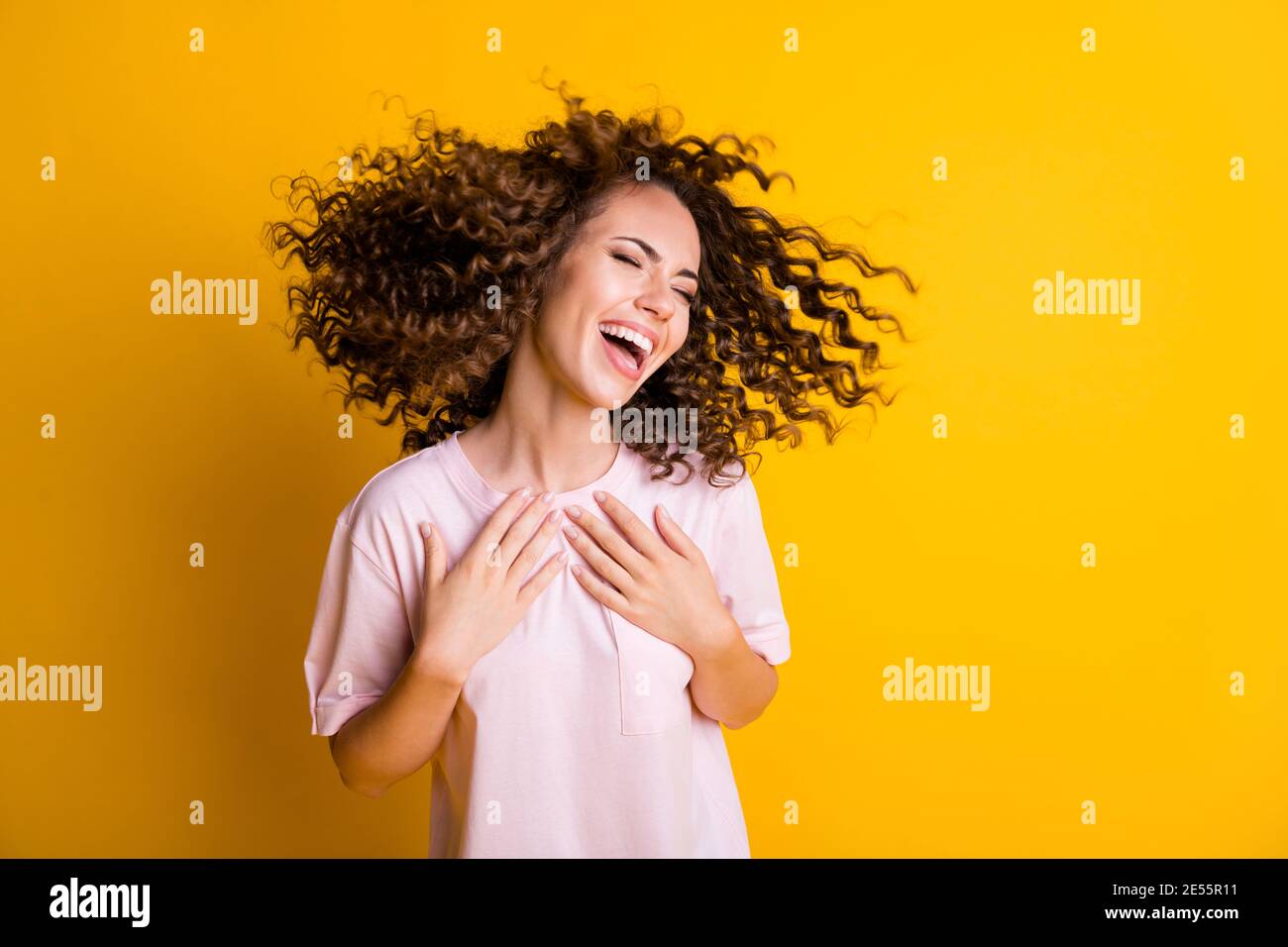Photo portrait of laughing girl touching chest with two hands isolated ...
