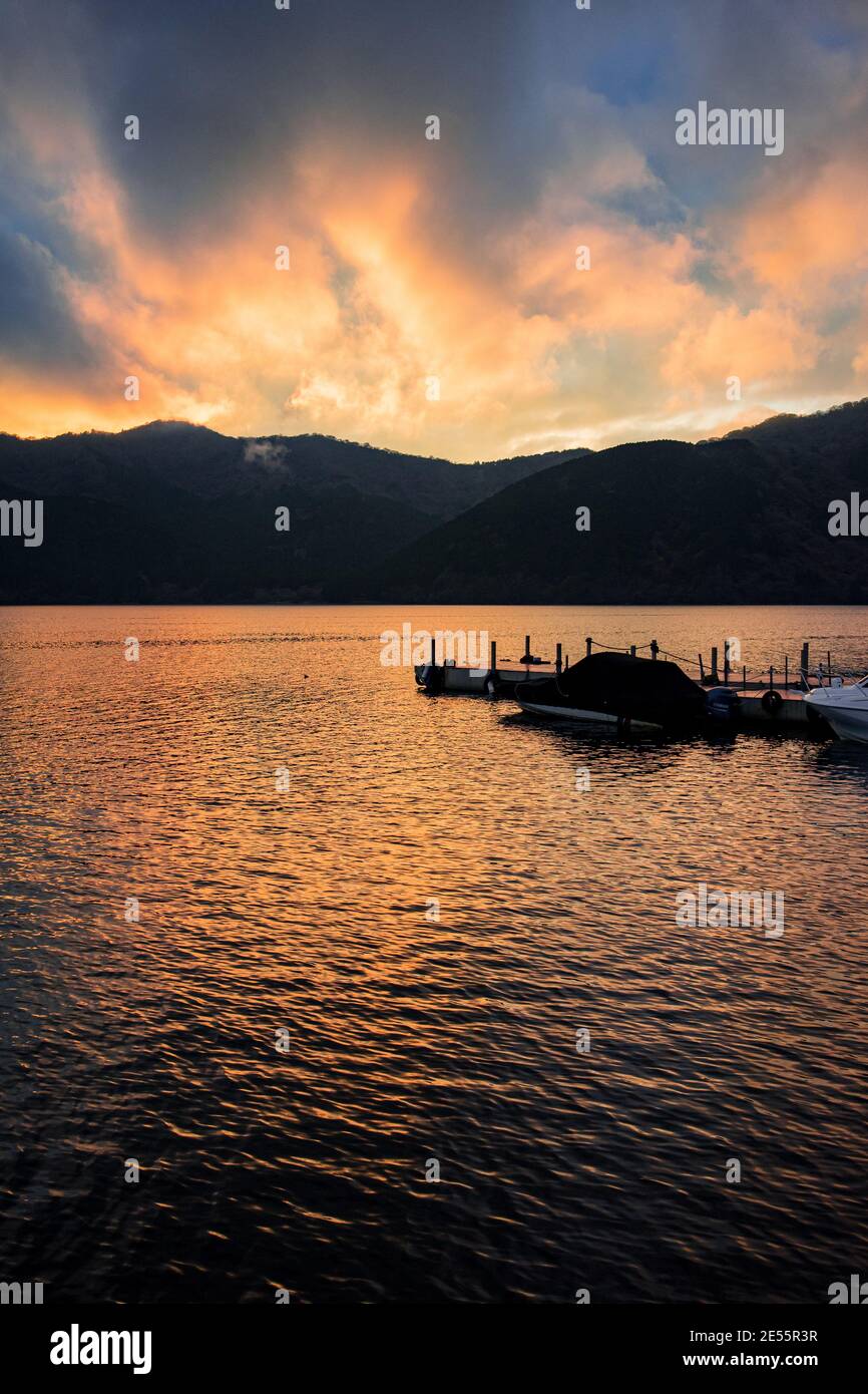 Vertical shot of the sunset sky with colorful clouds reflecting on the ...