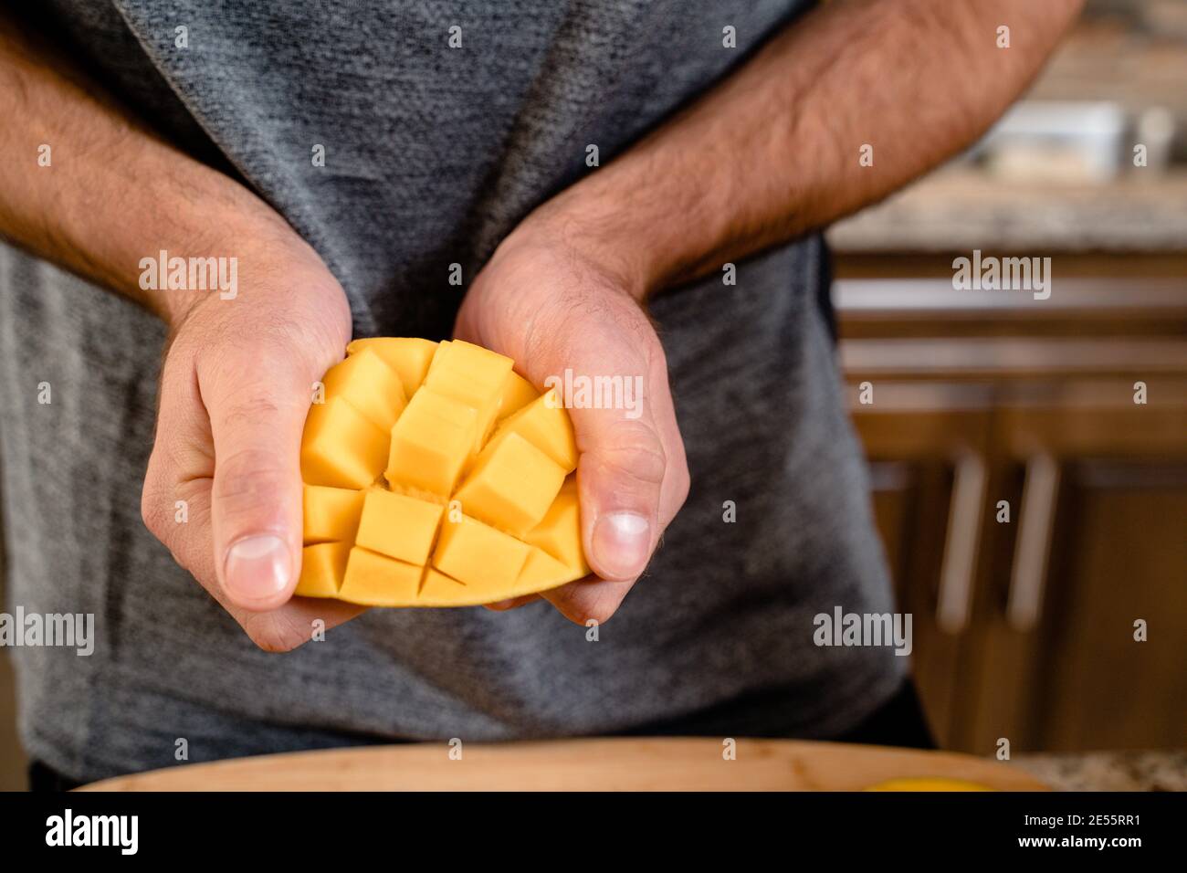 opening a sliced mango Stock Photo - Alamy
