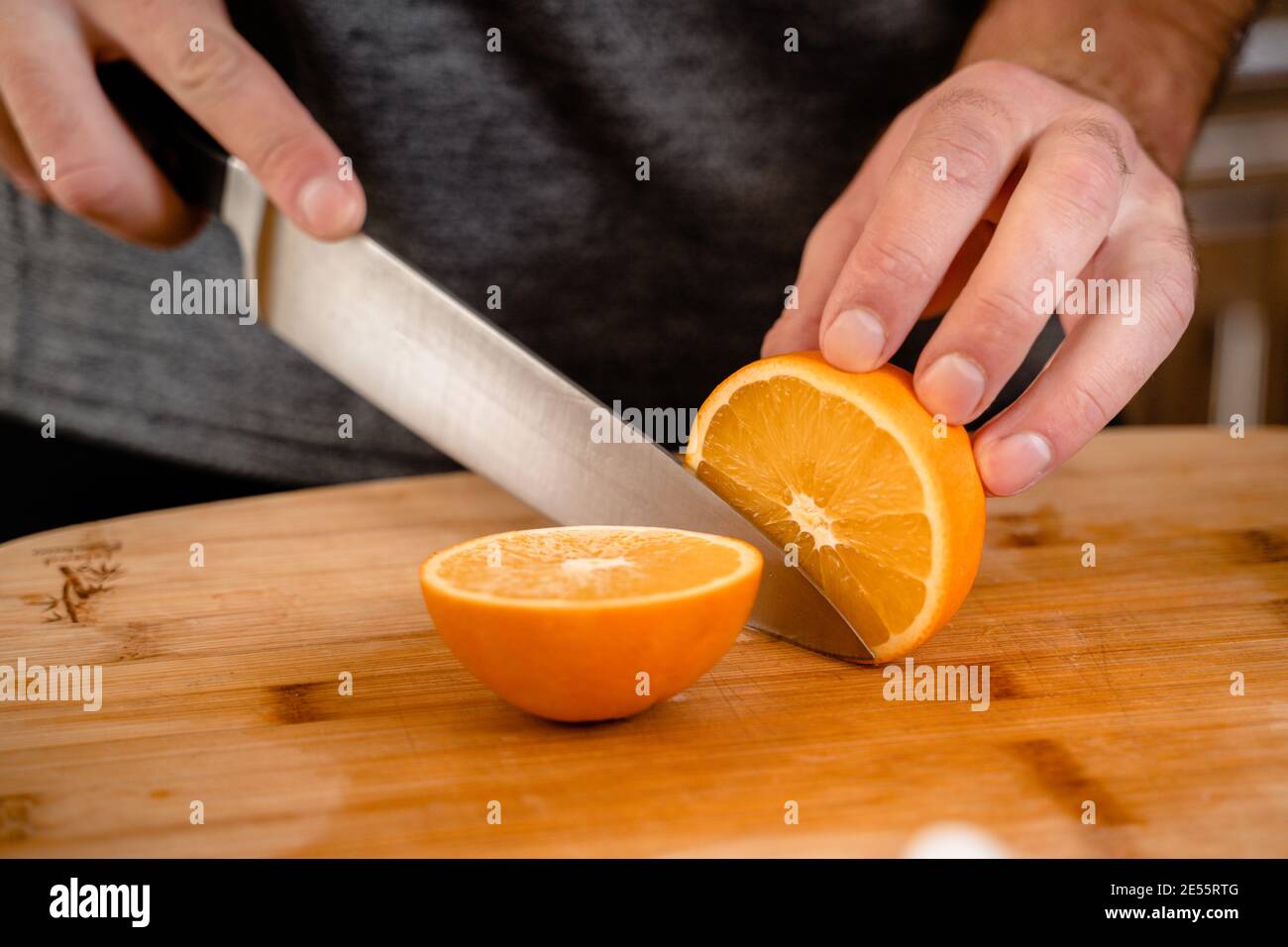 cutting an orange Stock Photo - Alamy