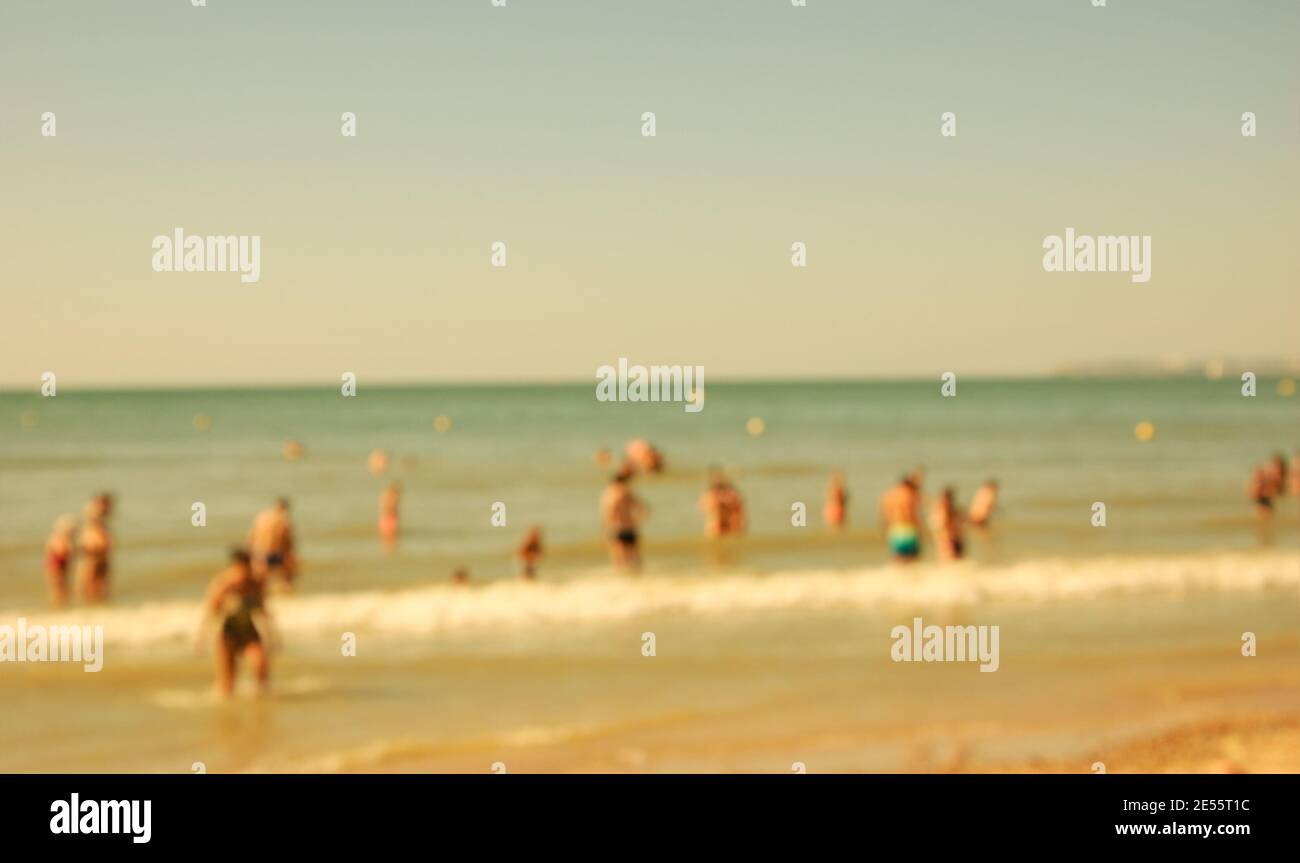 Blurred beach photo with bokeh. People relaxing on beach. Vacation ...