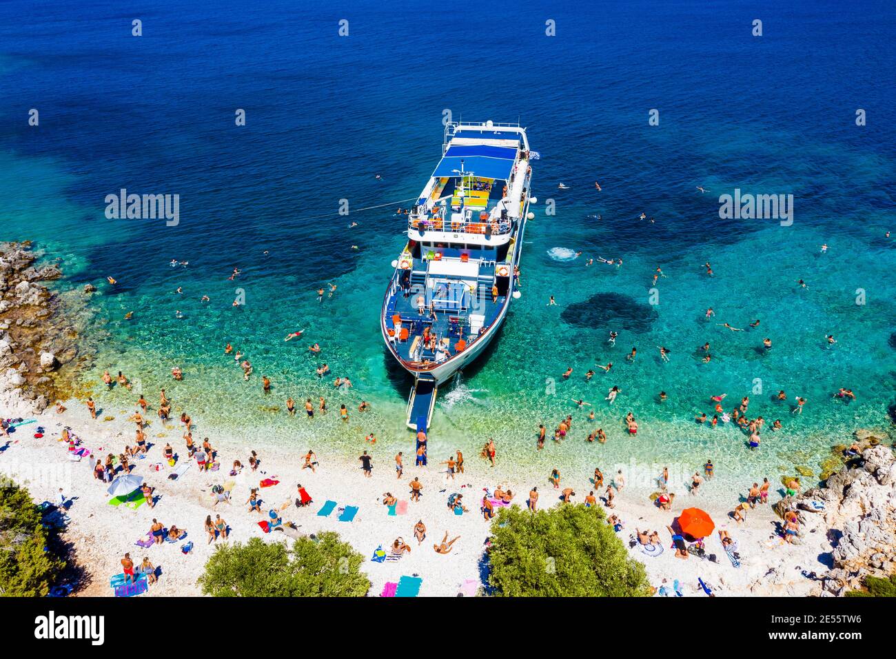 A busy private beach with a daily cruise ship full of families enjoying ...