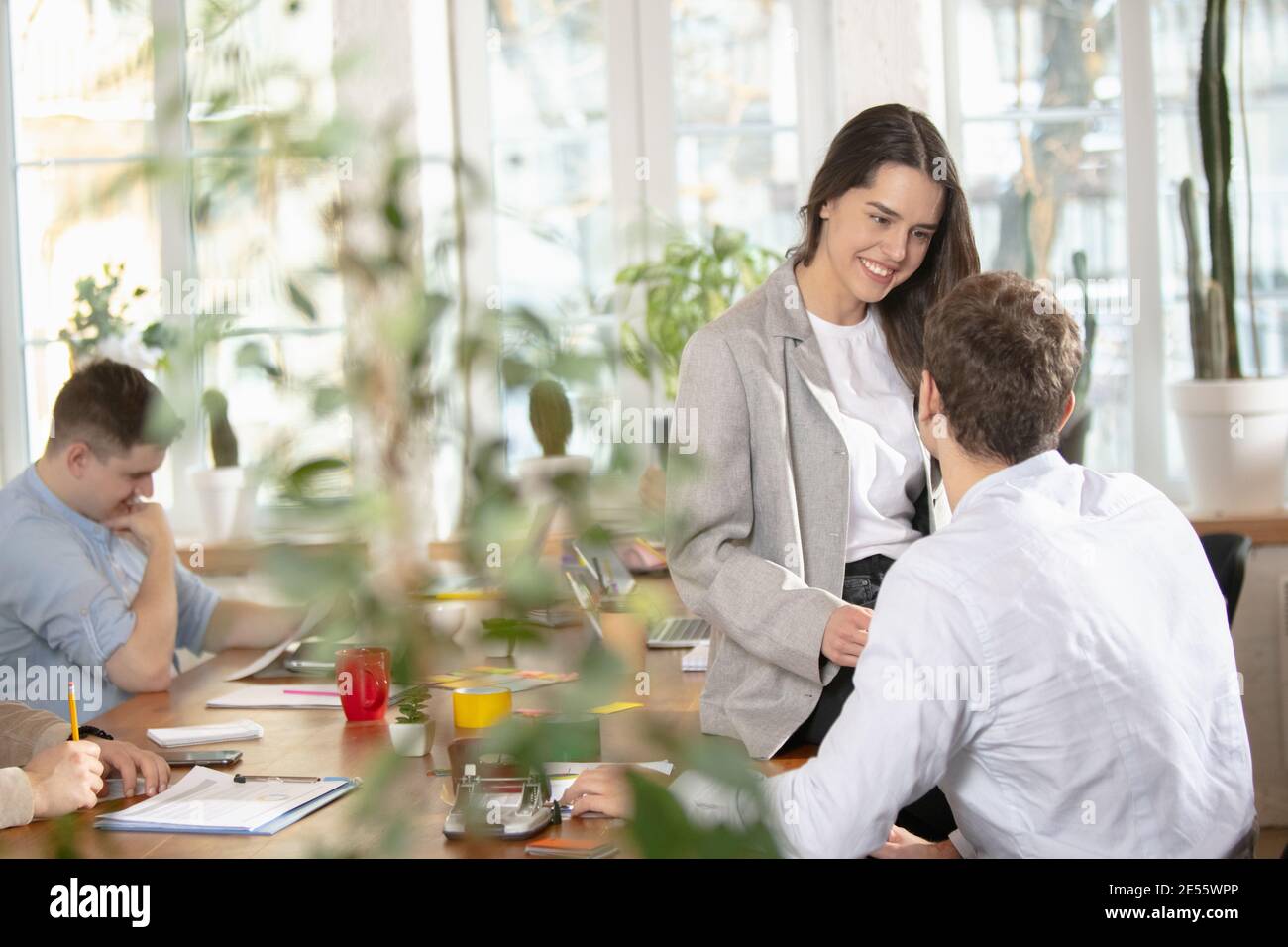 Project plan. Side view colleagues working together in a office using ...