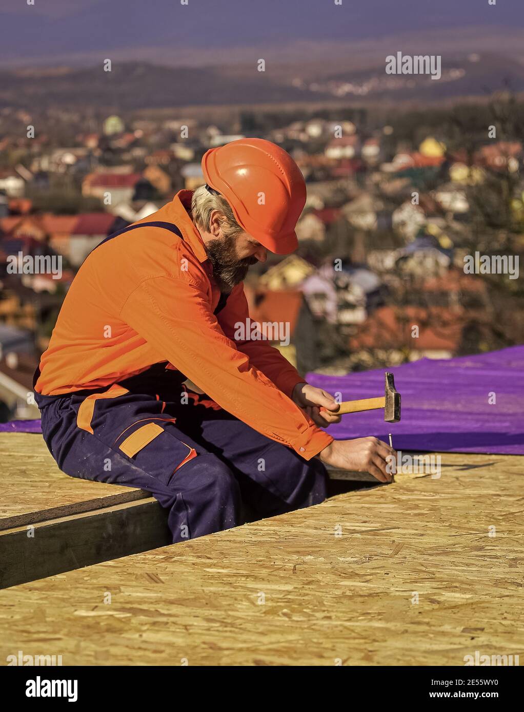 Roofer constructing new roof. Construction building. Waterproof sheet ...