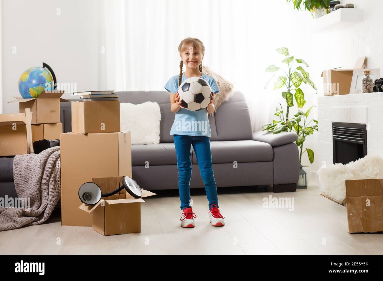Little girl moving into new house, near cardboard box Stock Photo - Alamy