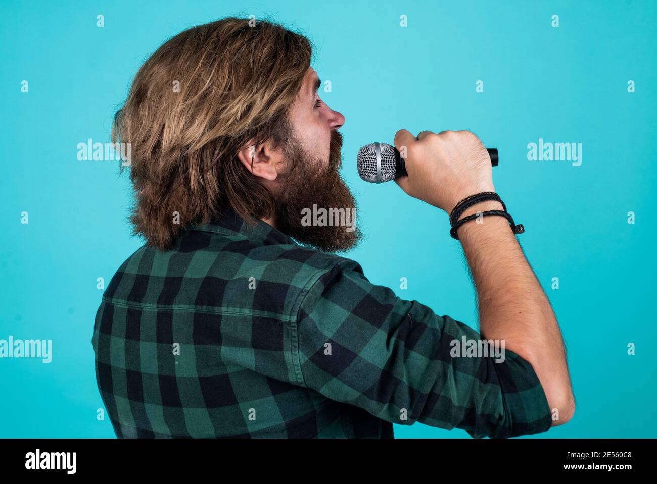 mature bearded man looking casual trendy singing in microphone, vocal ...