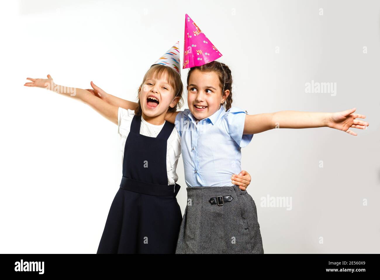 Two birthday girls in shirt blue school uniform dresses hat isolated on ...