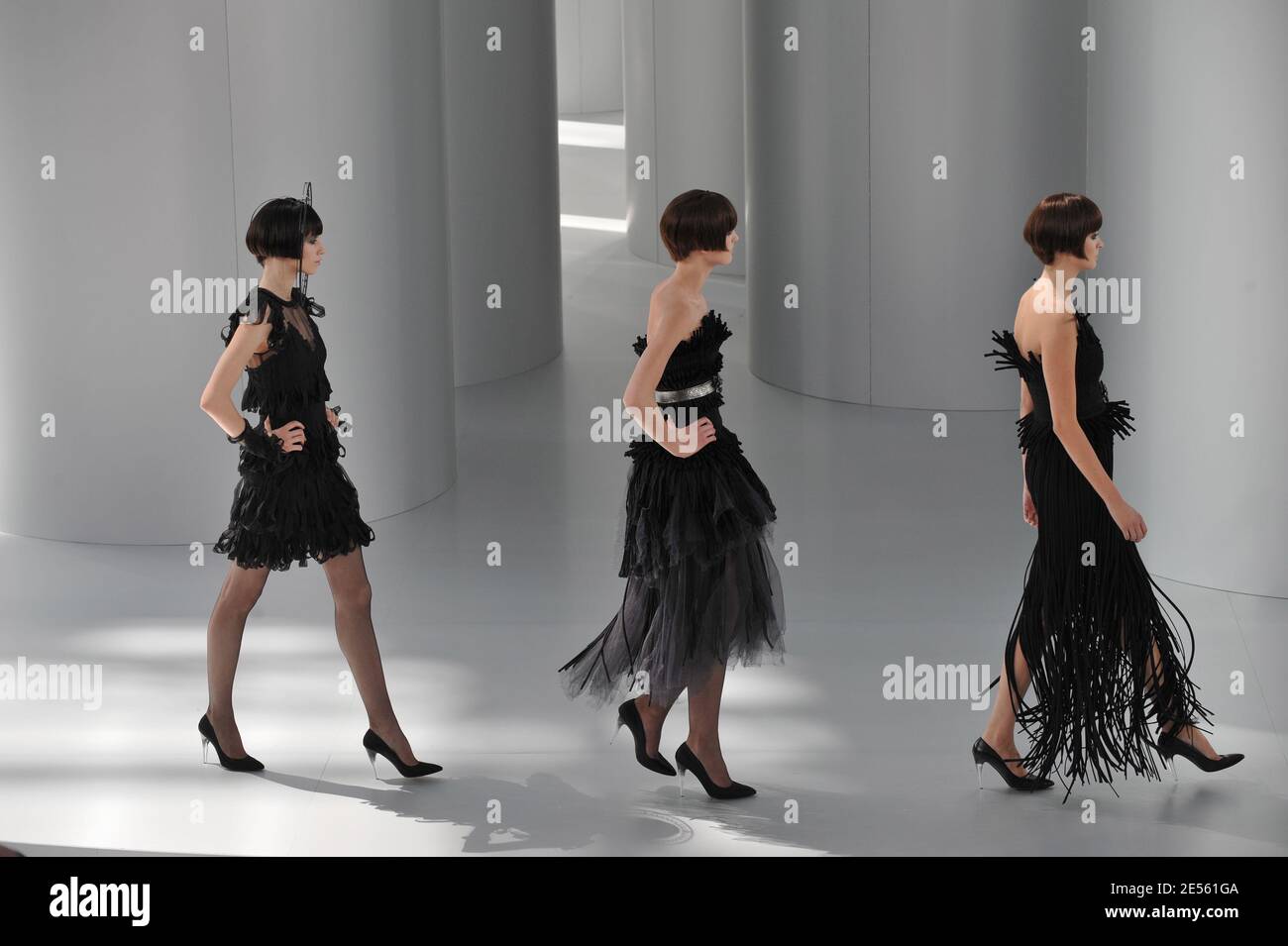 Models display a creation by designer Karl Lagerfeld for Chanel fall ...